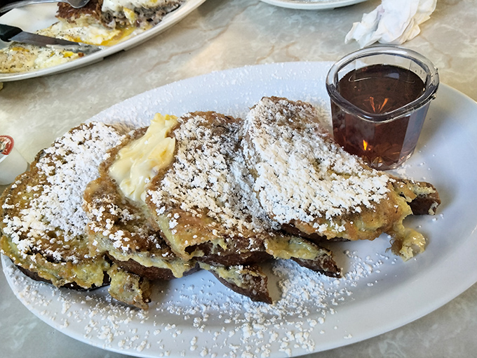 French toast so perfectly golden and powdered, it makes you wonder if breakfast is actually the most important meal of the day or just the most delicious.