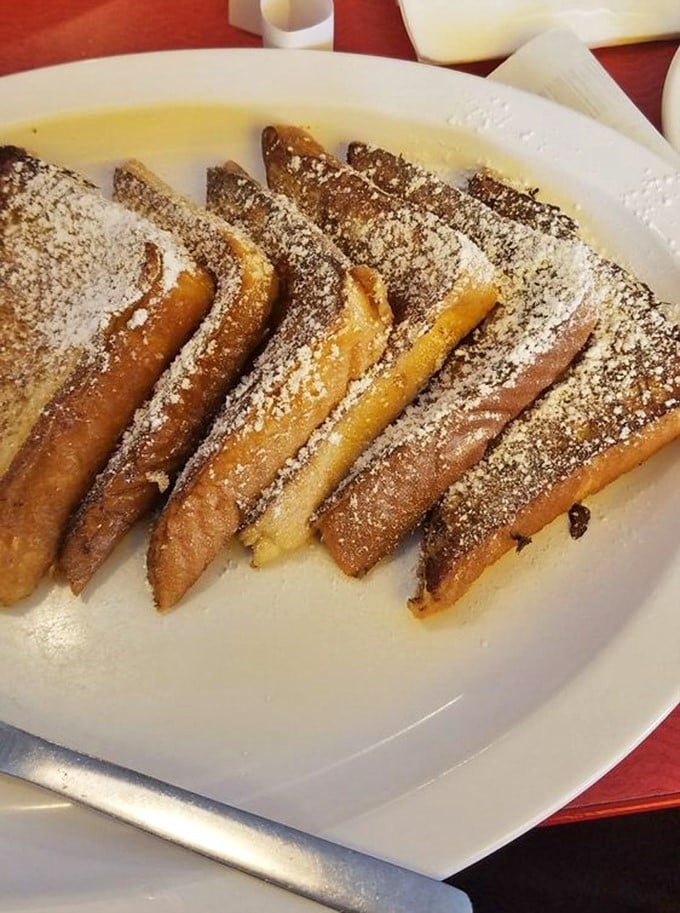 French toast dusted with powdered sugar&mdash;proof that bread can transcend its humble origins and become something worth setting an alarm for.