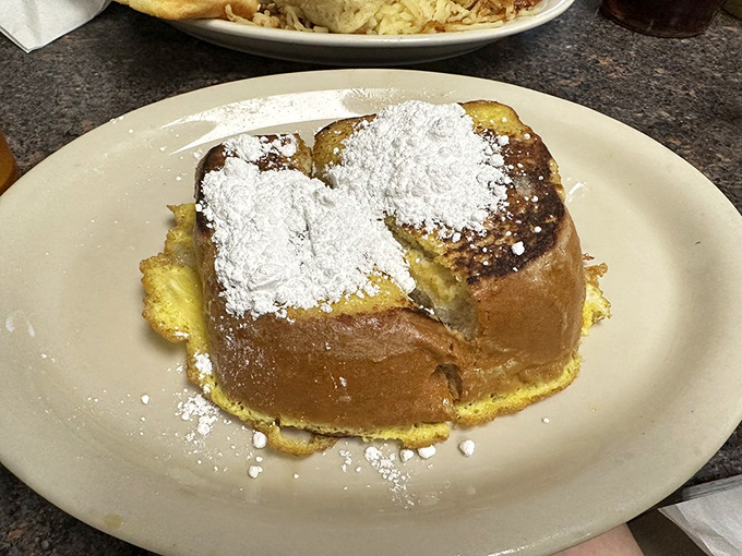 French toast that's had a proper introduction to the griddle. Dusted with powdered sugar like the first snow of winter on Texas soil.