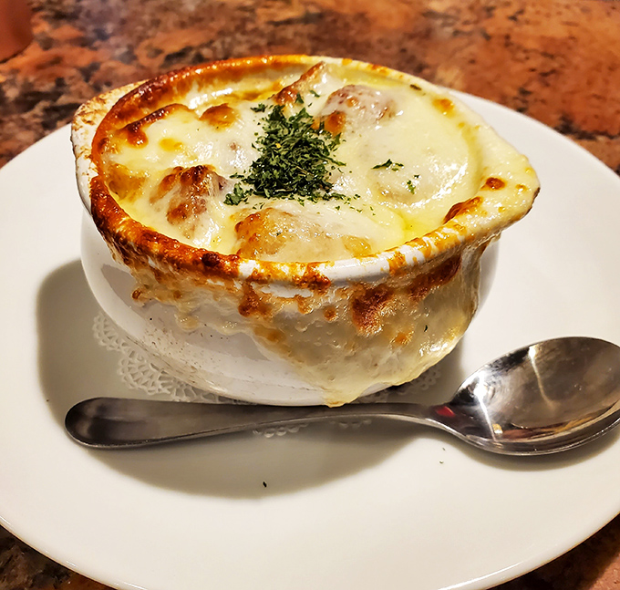 French onion soup that's worth the cheese pull. That bubbling, bronzed top is hiding a savory broth that took its sweet time getting delicious.