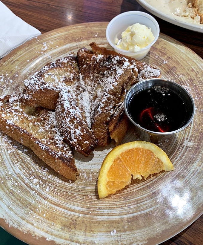 French toast that's been given the royal treatment: perfectly golden, dusted with powdered sugar, and served with real maple syrup and butter.
