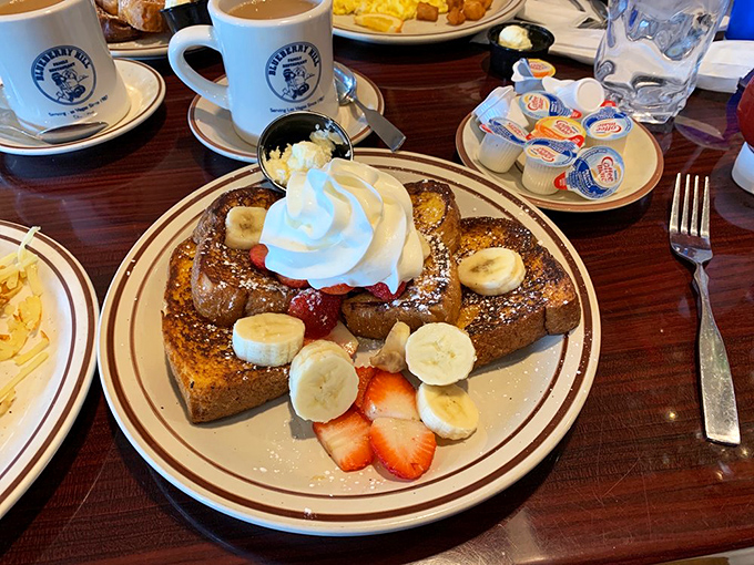 French toast that transforms ordinary bread into something extraordinary, adorned with fresh fruit like jewelry on breakfast royalty.