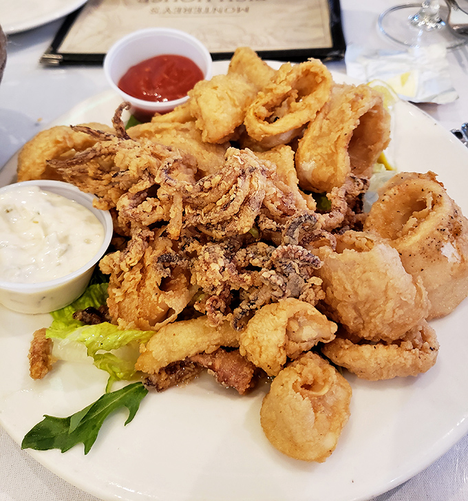 Fried calamari so perfectly golden, it deserves its own trophy. The dipping sauces are just there to feel included in the celebration.