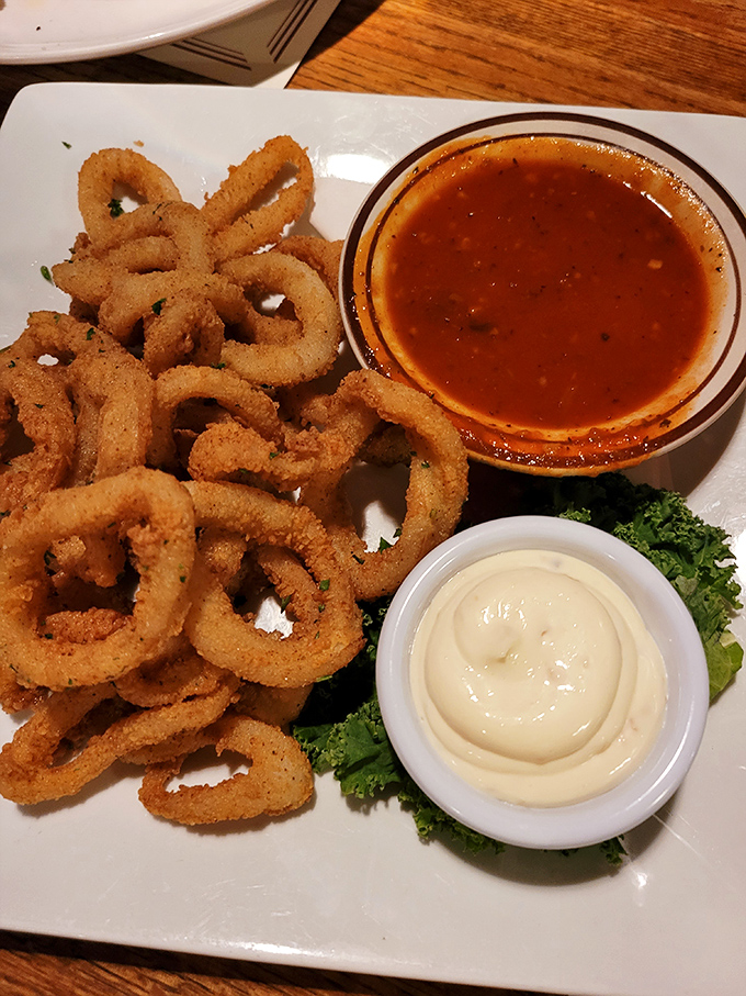 Golden-fried calamari rings surround dipping sauces like delicious life preservers in a sea of flavor possibilities.
