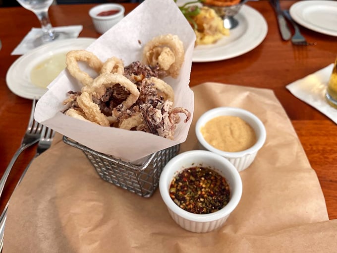 These aren't just calamari—they're crispy golden rings of joy, served with dipping sauces that make sharing an act of true friendship.
