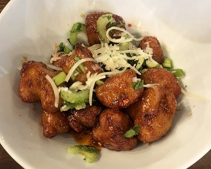 Forget everything you thought you knew about cauliflower. These golden-brown morsels with green onion and cheese are vegetable redemption on a plate.