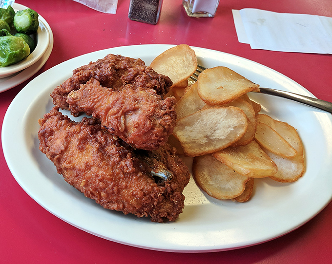 Fried chicken that would make your grandmother both jealous and proud, paired with potatoes sliced thin enough to read through.