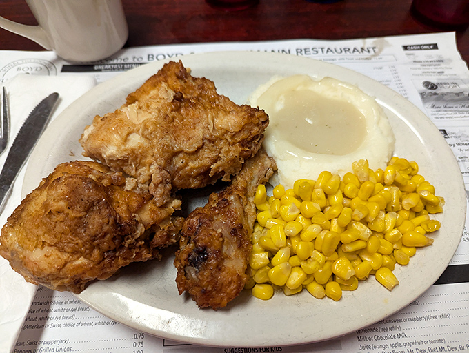 Fried chicken so perfectly golden it belongs in the Louvre. The corn and mashed potatoes are just showing off at this point.