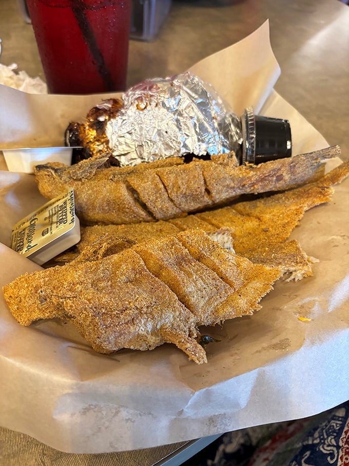 Whole catfish fillets wearing their cornmeal coats with pride, served with the kind of simplicity that screams confidence.