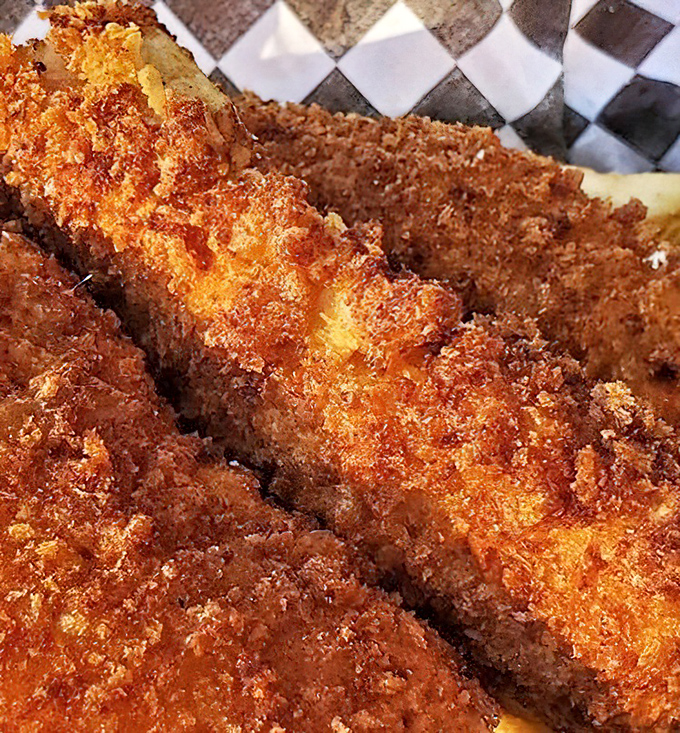 Close-up magic: That perfect golden crust shatters with each bite, revealing steamy, flaky fish that practically melts on your tongue.