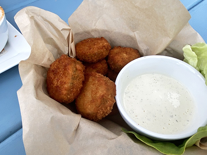 Golden-fried pickle perfection with creamy dipping sauce. These crispy morsels are the opening act that threatens to steal the whole show.