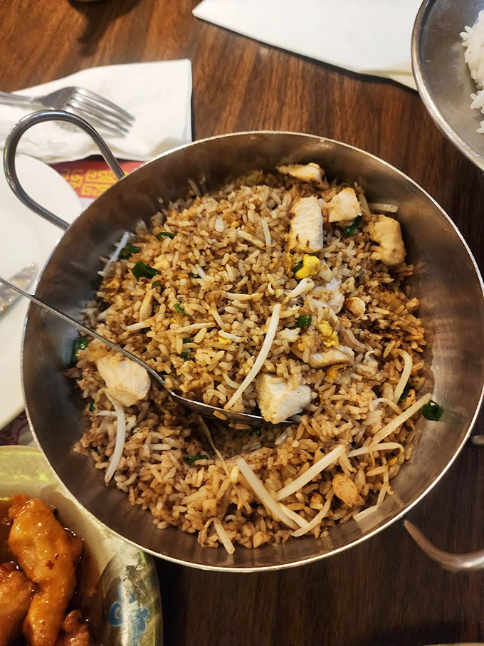 This isn't just fried rice; it's a treasure hunt where every forkful reveals bean sprouts, chicken, and other delights hiding among perfectly seasoned grains.