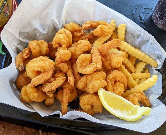 Fried shrimp and fries—the beach food equivalent of a standing ovation. That squeeze of lemon isn't optional, it's the director's cut.