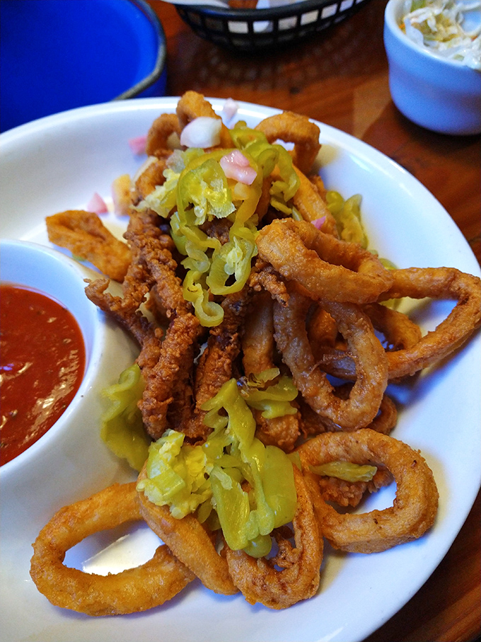 Crispy calamari rings topped with banana peppers&mdash;a textural symphony that proves fried food is indeed a love language. 