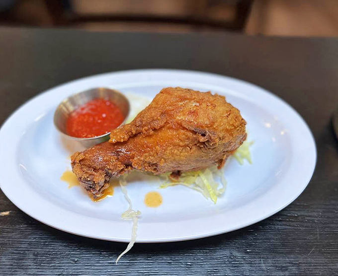Fried chicken so perfectly golden it belongs in Fort Knox, served with a side of pepper jelly that'll make your taste buds dance.