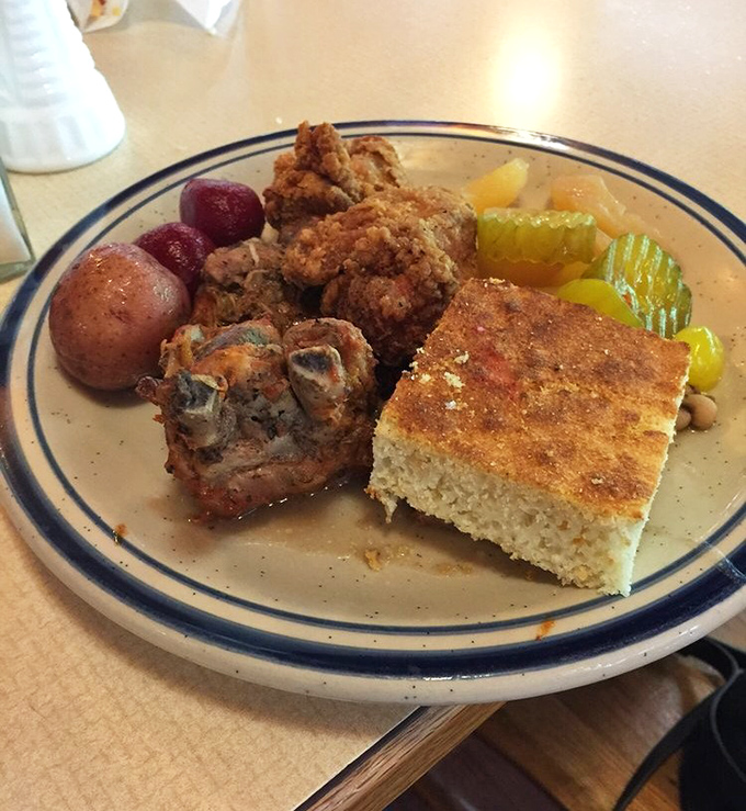 Southern cooking's greatest hits on one plate—golden fried chicken, cornbread with a perfect crust, and sides that refuse to be overshadowed.
