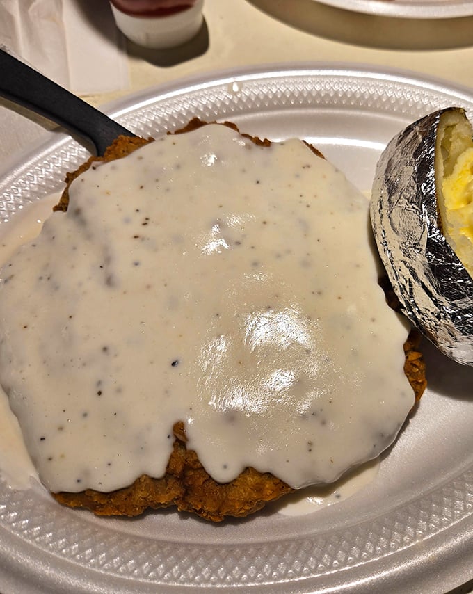 Country fried steak swimming in creamy pepper gravy &ndash; a dish so comforting it should come with its own therapist's couch and a box of tissues.