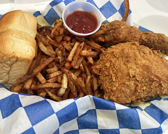 The holy trinity of comfort food: crispy fries, golden chicken, and a roll that knows its supporting role. Add ketchup and achieve nirvana.