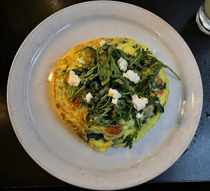 This frittata doesn't just sit on the plate &ndash; it proudly displays its farm-fresh ingredients like a garden party happening inside an egg.
