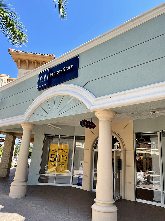 GAP Factory's columned entrance showcases those magical yellow "Extra 50% Off" signs that make wallets open themselves.