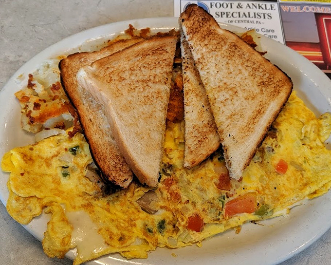 Garden omelets: where vegetables go to fulfill their breakfast destiny. Those perfectly golden triangles of toast are the unsung heroes. 