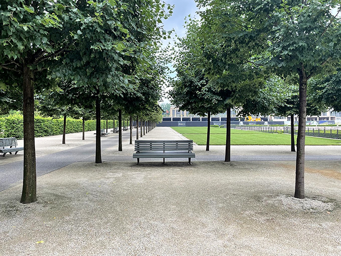 A tree-lined path where serenity comes standard. This shaded walkway offers the perfect setting for contemplating life's big questions or just your lunch options.