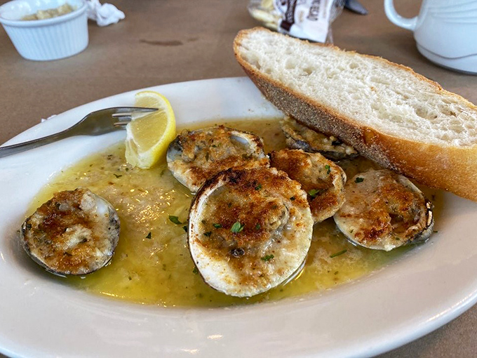 Garlic clams swimming in butter with a slice of crusty bread standing by for dipping duty. The kind of dish that makes you forget table manners exist.
