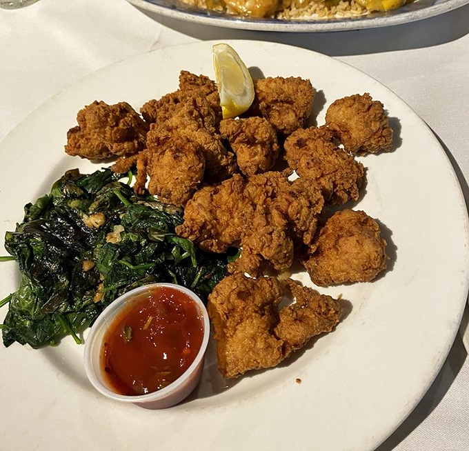 Fried gator tail&mdash;Florida's answer to popcorn chicken&mdash;served with saut&eacute;ed greens that provide the perfect counterbalance to the crispy, tender nuggets.