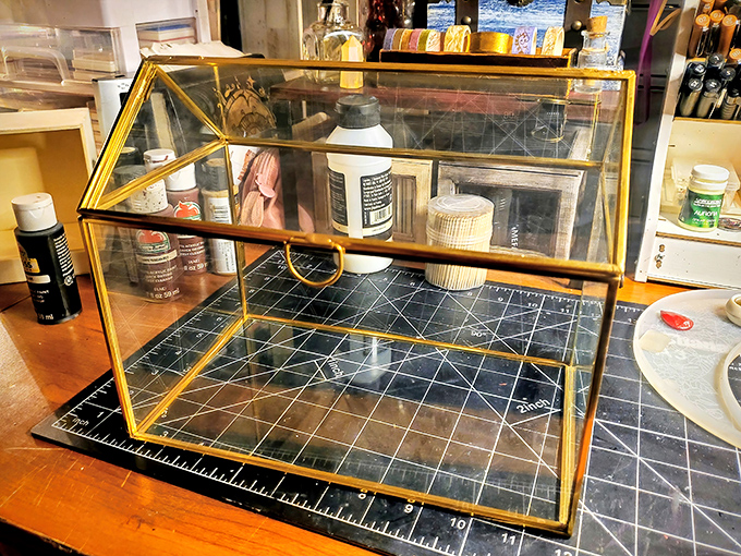A vintage glass display case waits for its next purpose. Perhaps displaying collectibles, or becoming the world's fanciest terrarium&mdash;the possibilities are endless.