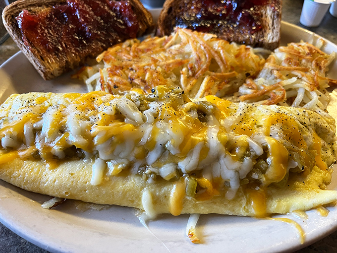This isn't just an omelet – it's a cheese-blanketed masterpiece with hash browns that achieve the perfect crisp-to-tender ratio. Morning glory on a plate!