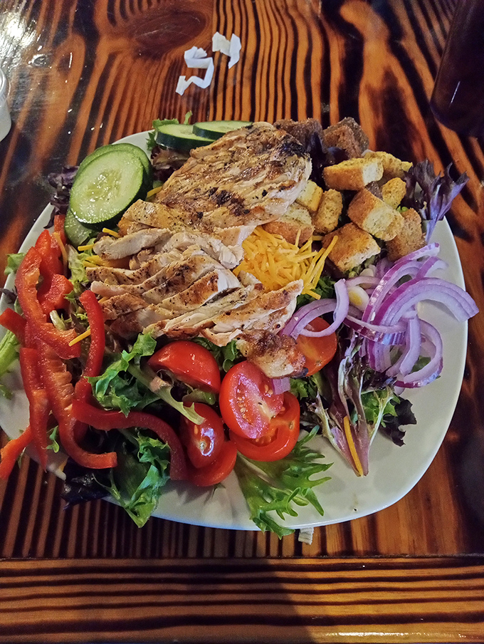 Garden party meets protein powerhouse in this vibrant chicken salad. Fresh veggies, perfectly grilled chicken, and those croutons? They're the unsung heroes of this colorful masterpiece.