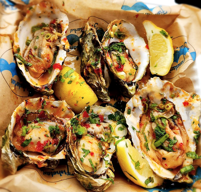 These grilled oysters, glistening with herb butter and kissed by flame, might just be the reason California hasn't fallen into the ocean yet.