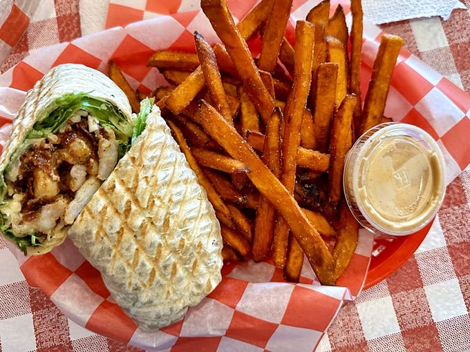 This grilled wrap isn't just lunch&mdash;it's edible architecture with layers of flavor held together in a perfectly pressed tortilla alongside crispy fries.