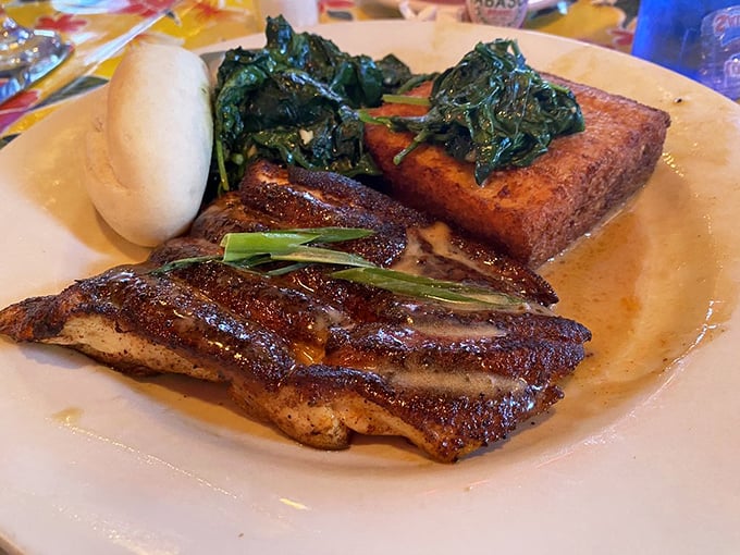 Blackened fish that's seen just enough heat to develop a personality, resting alongside wilted spinach and a cornbread square that deserves its own fan club.
