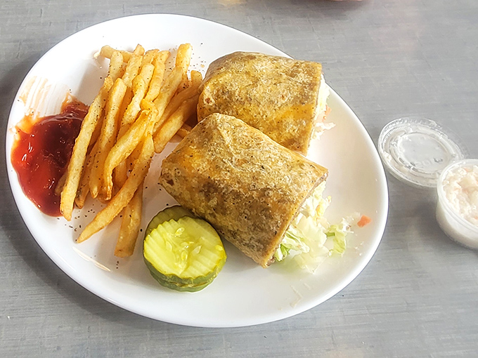 A sandwich that demands two hands and zero distractions. Golden fries, a pickle sentinel, and enough filling to make lunch last until dinner.