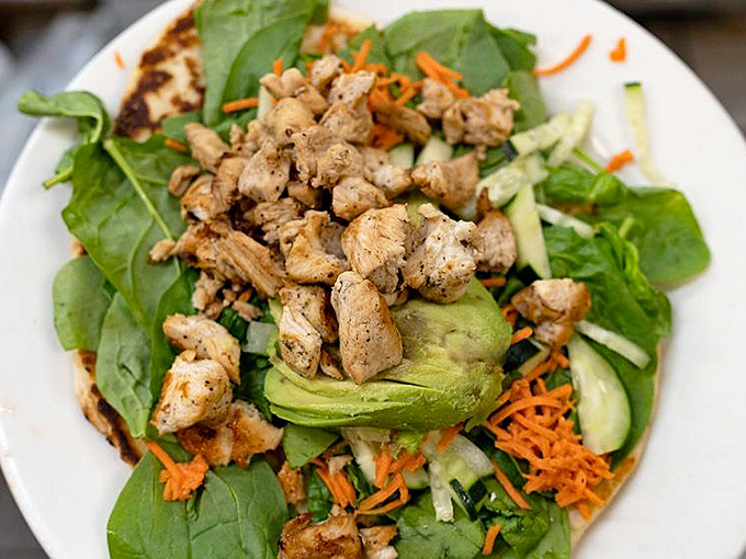 Fresh greens, perfectly seasoned chicken, and a rainbow of vegetables create a salad that makes you feel virtuous and indulgent all at once&mdash;a rare culinary magic trick.