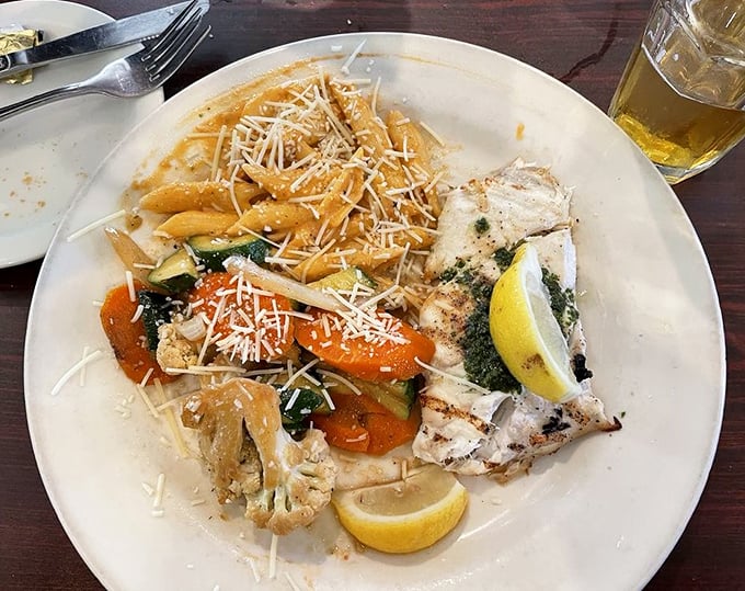 Perfectly grilled fish alongside pasta that's been thoroughly introduced to Parmesan. The lemon wedge isn't just garnish&mdash;it's essential punctuation.