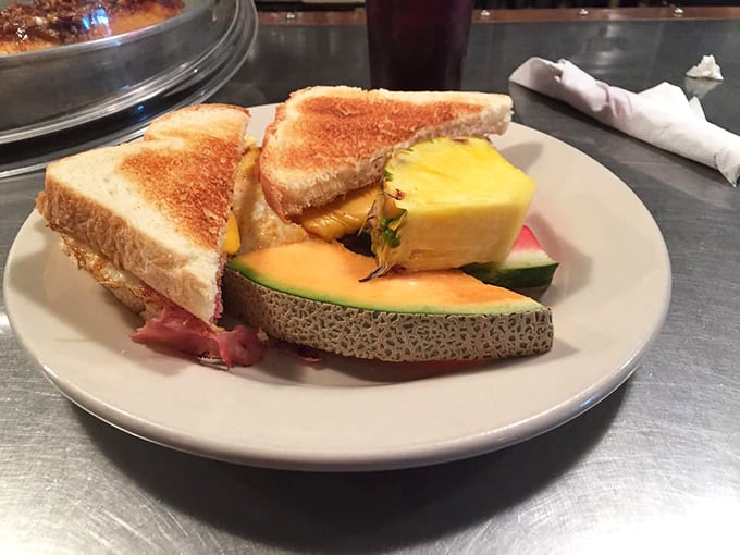 A grilled ham sandwich that understands the importance of proper fruit-to-bread ratio. That cantaloupe slice is practically winking at you.