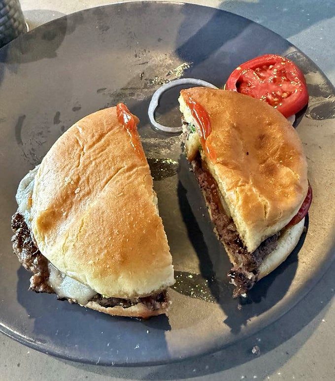 A burger cut in half isn't just practical&mdash;it's a promise that what's inside is worth showing off, like a culinary centerfold.