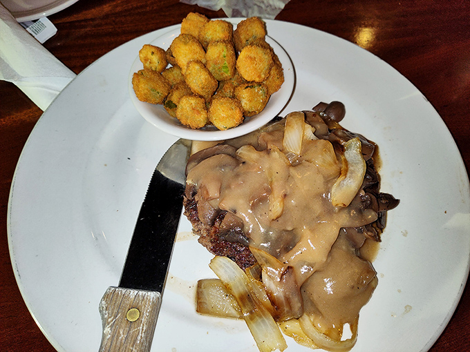 Not just a hamburger steak but a masterpiece of comfort food architecture, with mushroom gravy cascading down like a savory waterfall.