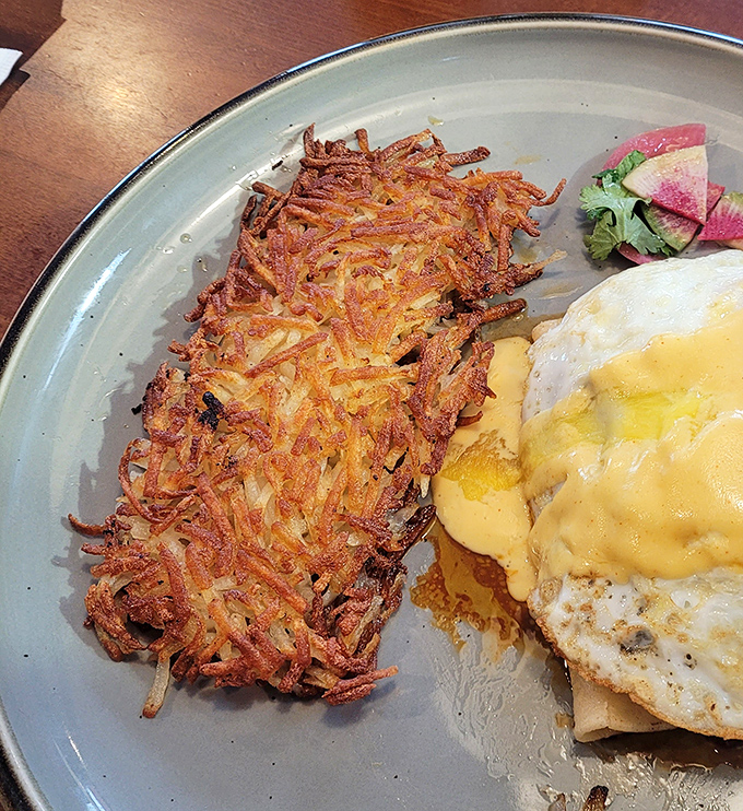 Hash browns so perfectly crispy they deserve their own fan club, shown here accompanying eggs with the loyalty of a faithful sidekick.