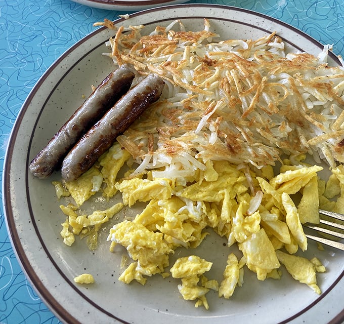 These aren't just hash browns &ndash; they're golden potato perfection with sausage links standing by like delicious sentries guarding your breakfast happiness.