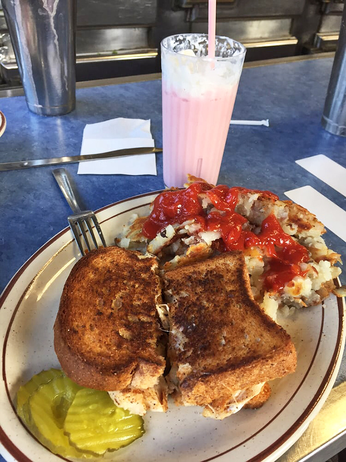 A grilled cheese sandwich and hash browns with ketchup sit beside a strawberry shake&mdash;the holy trinity of diner comfort that transcends generations.