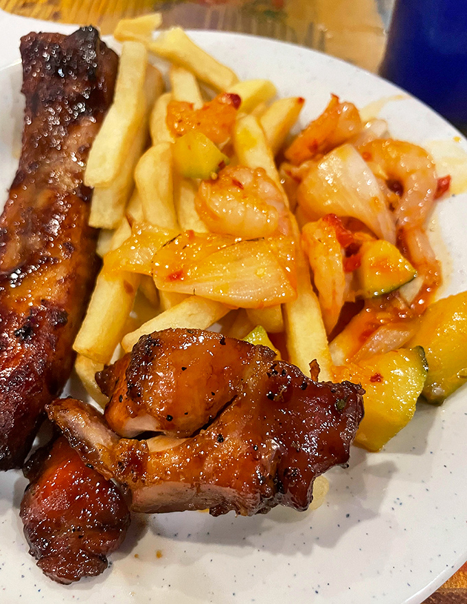 The holy trinity of buffet indulgence: caramelized ribs, golden fries, and sweet-spicy chicken—proof that sometimes the best plate is the one with no empty space.