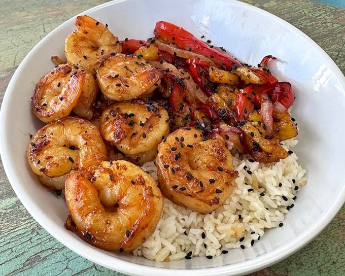 These perfectly seared shrimp perched atop rice aren't just dinner&mdash;they're a vacation for your taste buds, no passport required.