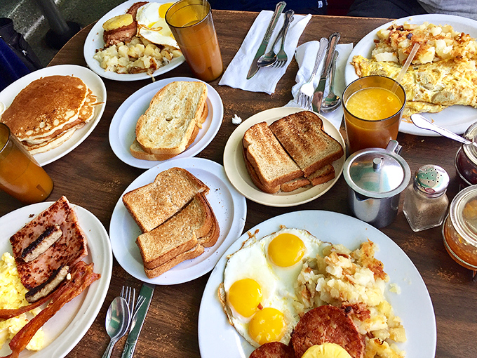 Breakfast paradise found! Golden pancakes, perfectly cooked eggs, and crispy bacon spread across the table like a morning feast worthy of champions.