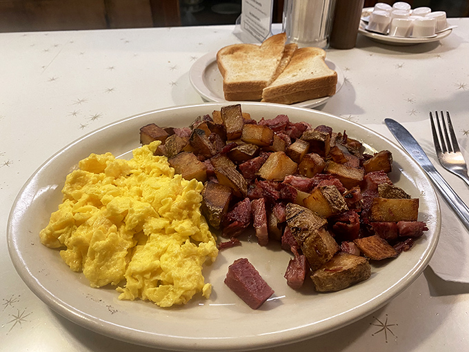 Breakfast of champions: sunshine-yellow eggs alongside corned beef hash that's been properly introduced to the griddle. The toast stands by, ready for its supporting role.