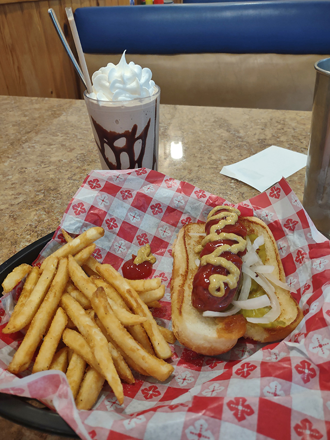 Hot dogs and fries served on classic red and white checkered paper&mdash;comfort food that speaks a universal language of deliciousness. 