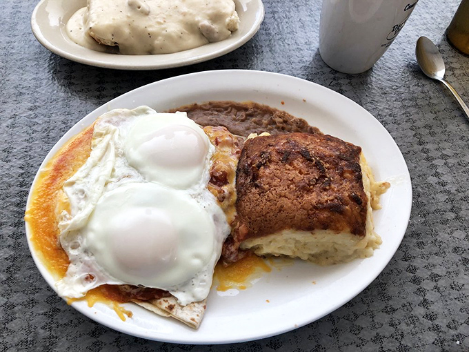 Two sunny-side up eggs nestled on a bed of perfectly crisped hash browns. This plate has more sunshine than a Florida afternoon.