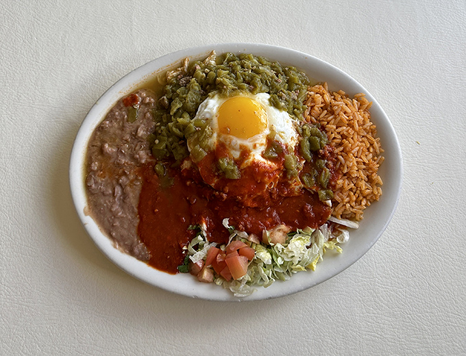 Huevos rancheros with an egg perched like royalty atop a kingdom of chile, beans, and rice. Breakfast doesn't get more regal than this.